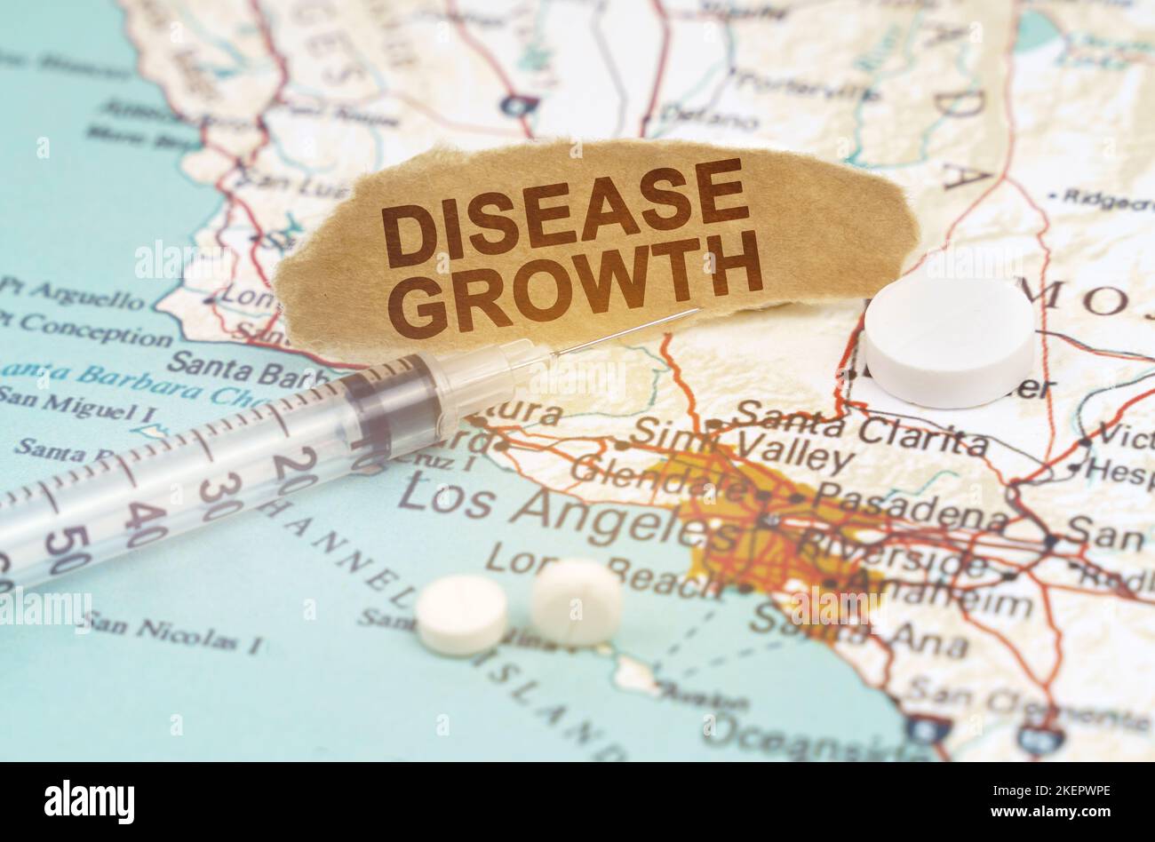 Medicine and health concept. On a map of California lies a syringe ...