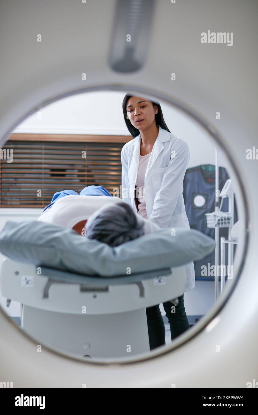 In we go...a senior woman being comforted by a doctor before and MRI ...