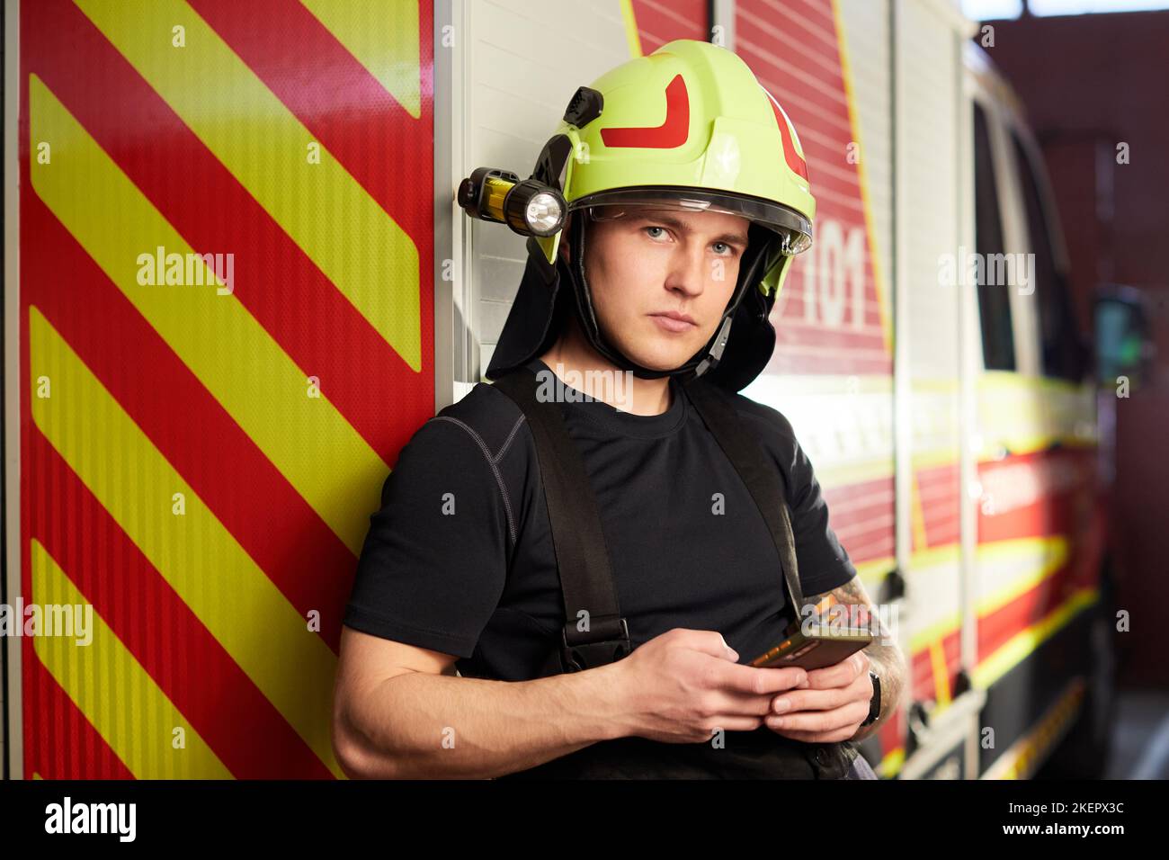 Portrait of a firefighter standing in front of a fire engine Stock ...