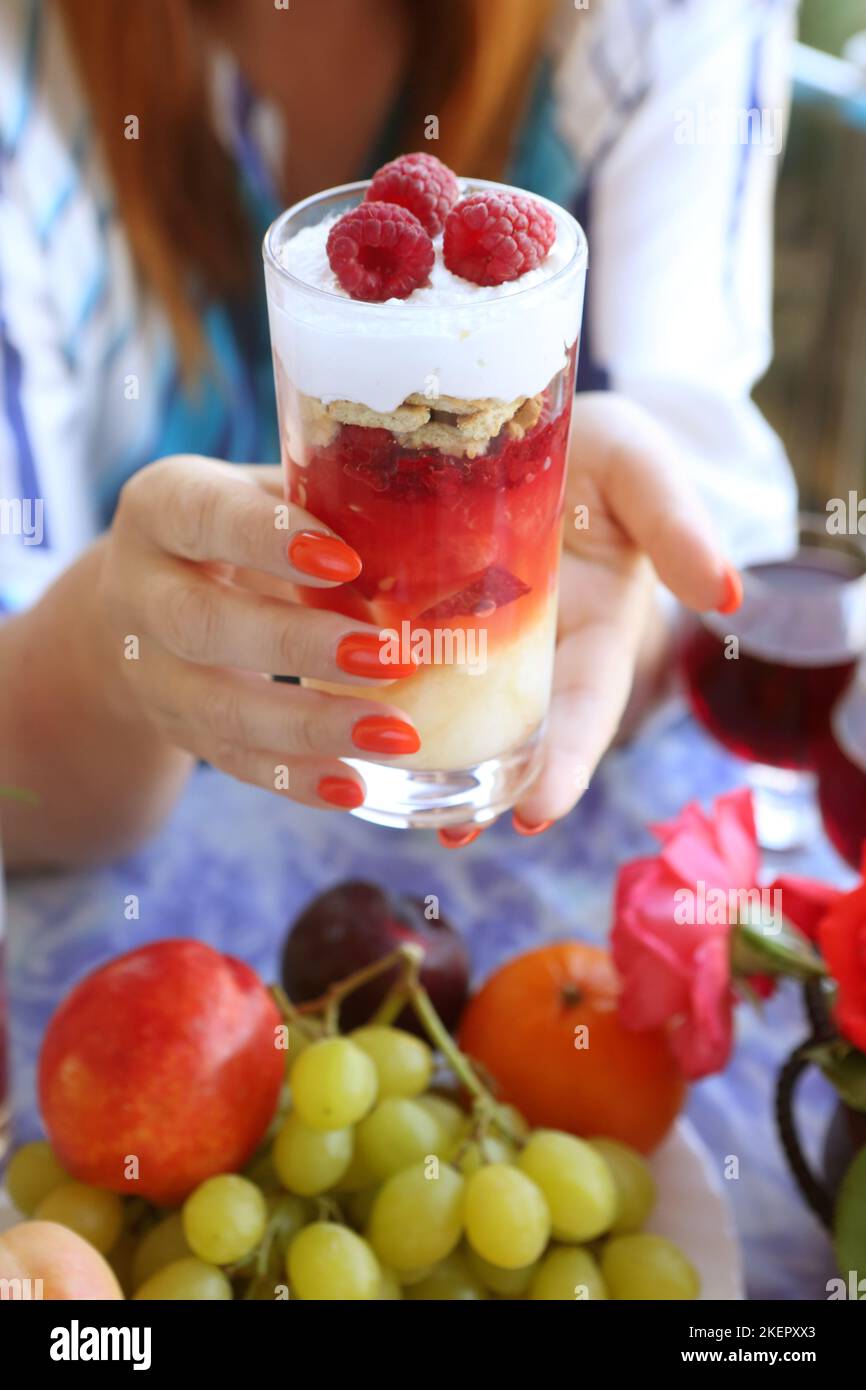 Woman's hands with fruit dessert Stock Photo - Alamy
