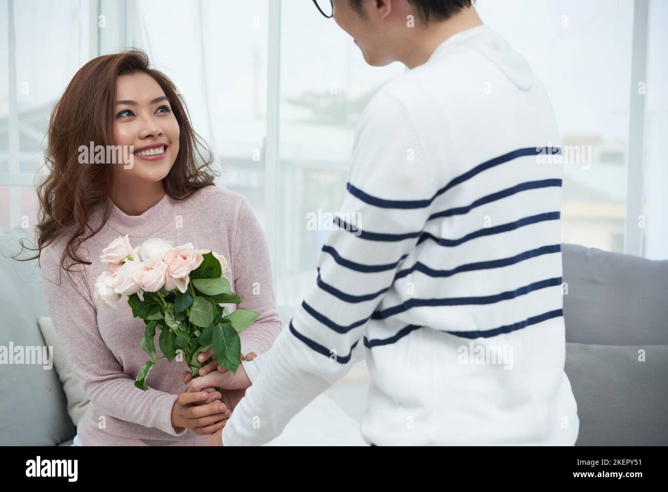 Happy beautiful young woman receiving flowers for her boyfriend Stock ...