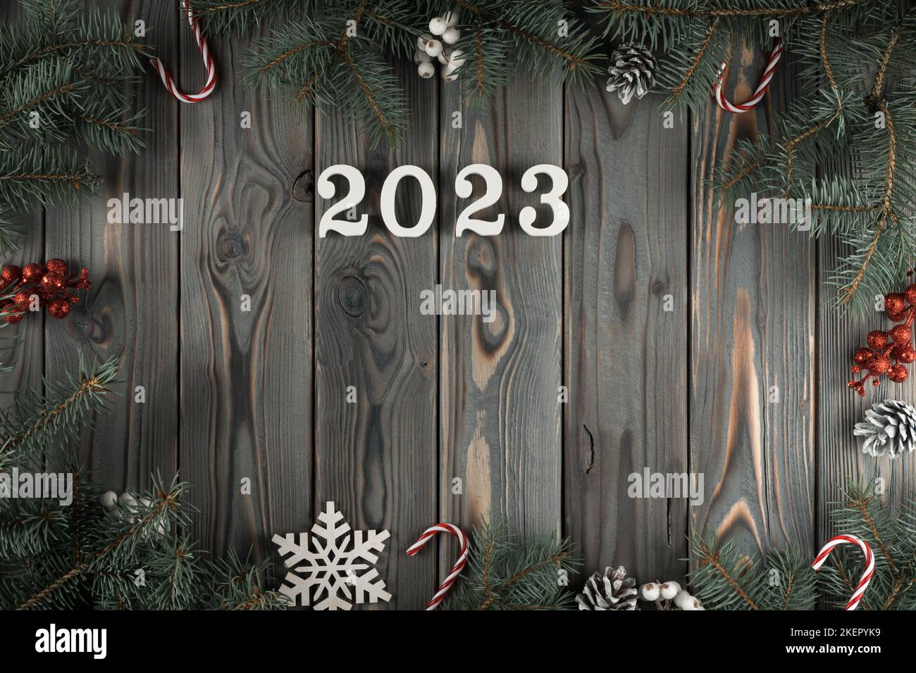 Handmade decorative frame from spruce branches on gray wooden wall, top ...