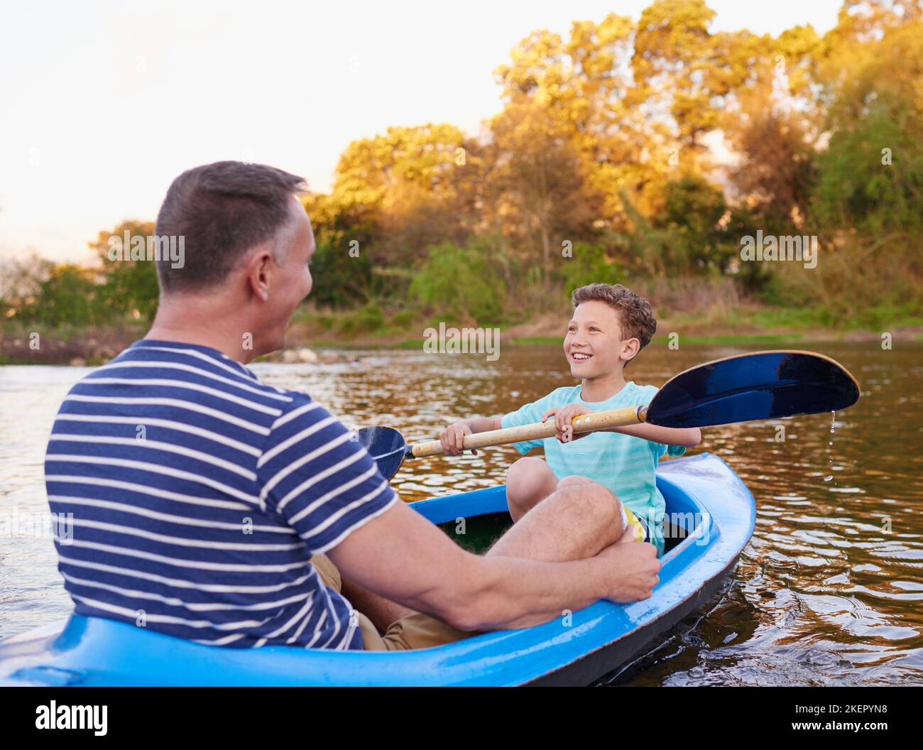 Enjoying a father and son vacation. a father and son rowing a boat ...