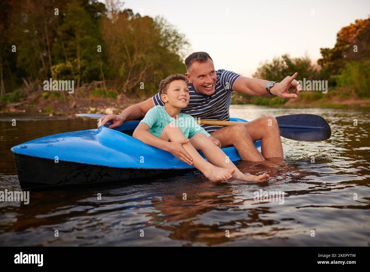 Lets go further down river. a father and son sitting in a rowboat ...