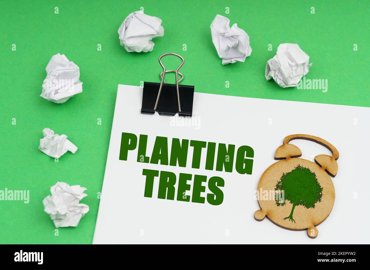 Environmental concept. On a green background there is a white sheet, on ...