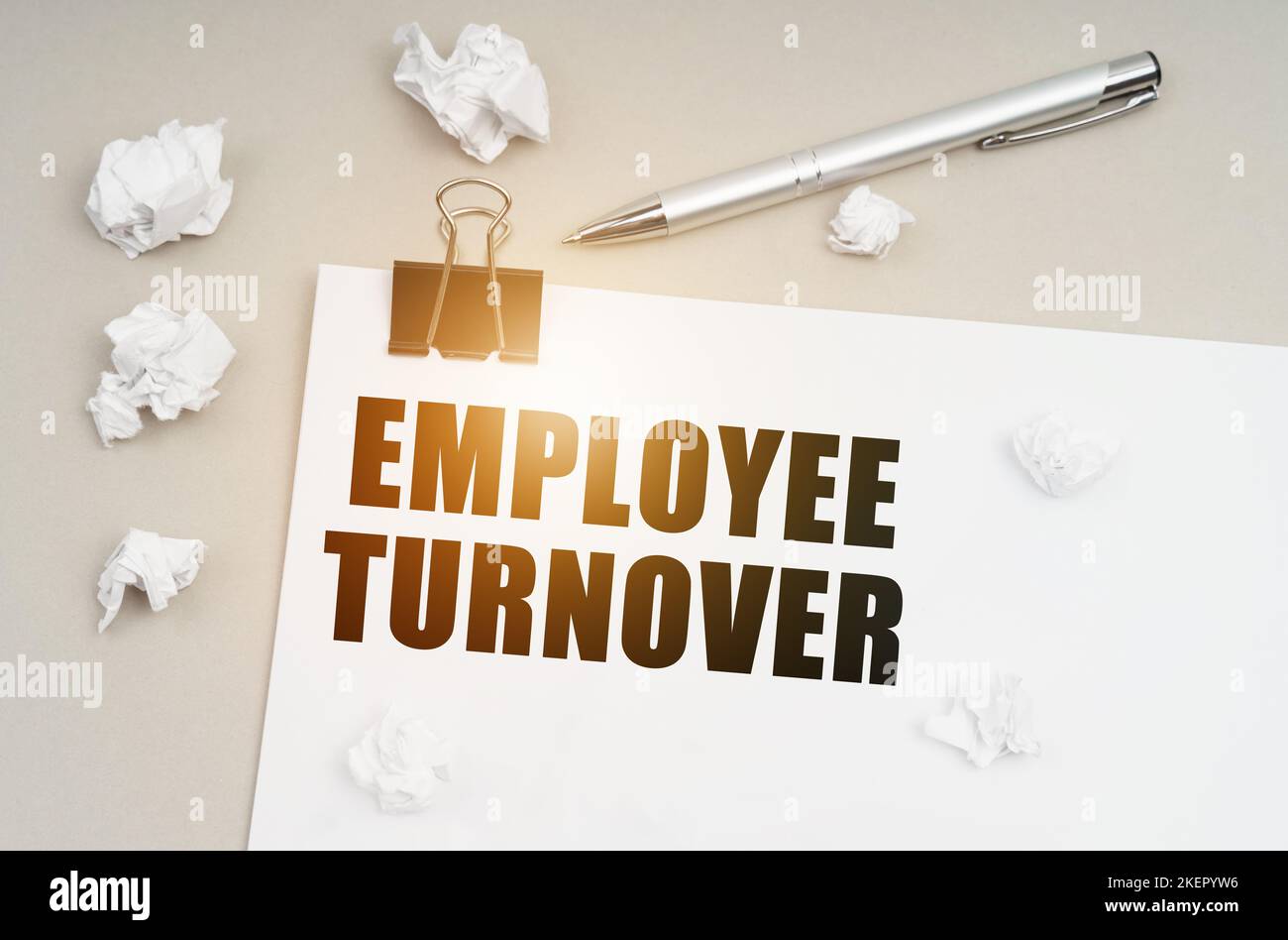 Economy and business concept. On a gray surface, a pen, crumpled paper ...