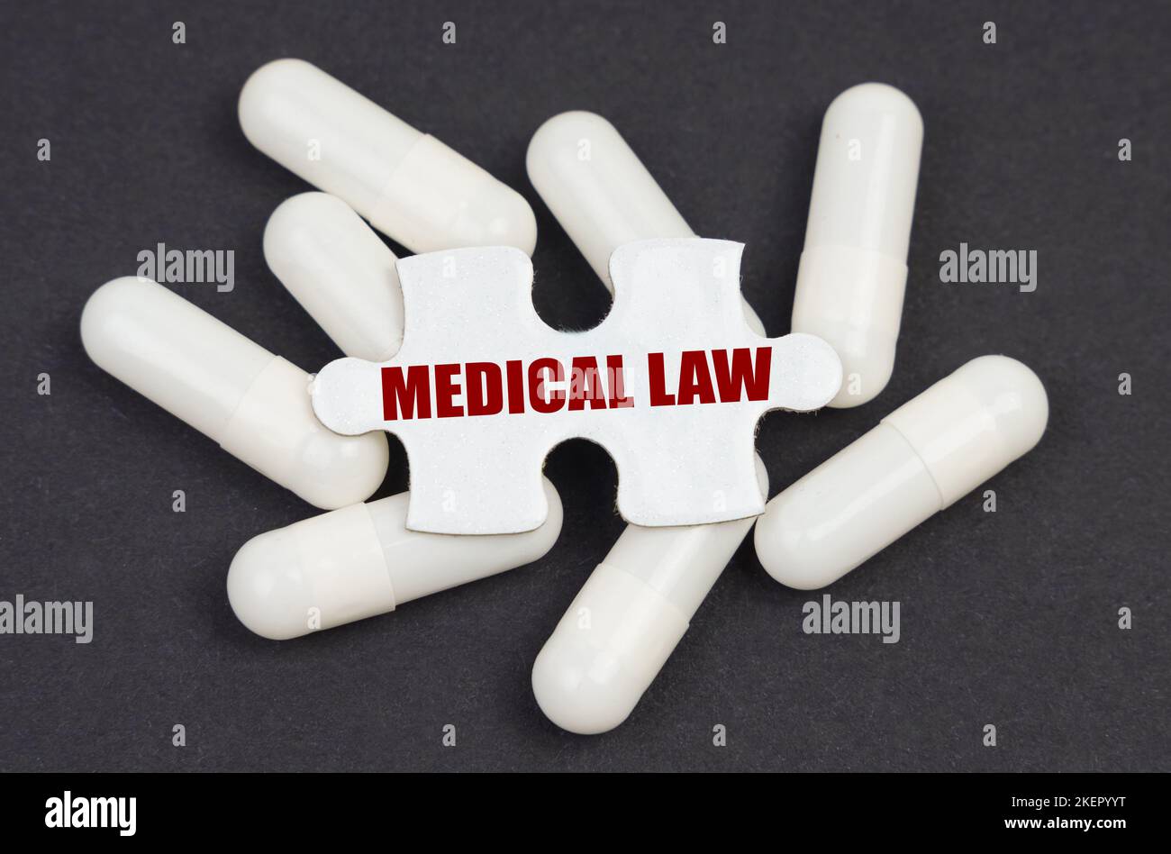 Medicine concept. On a black background, capsules and a puzzle with the ...