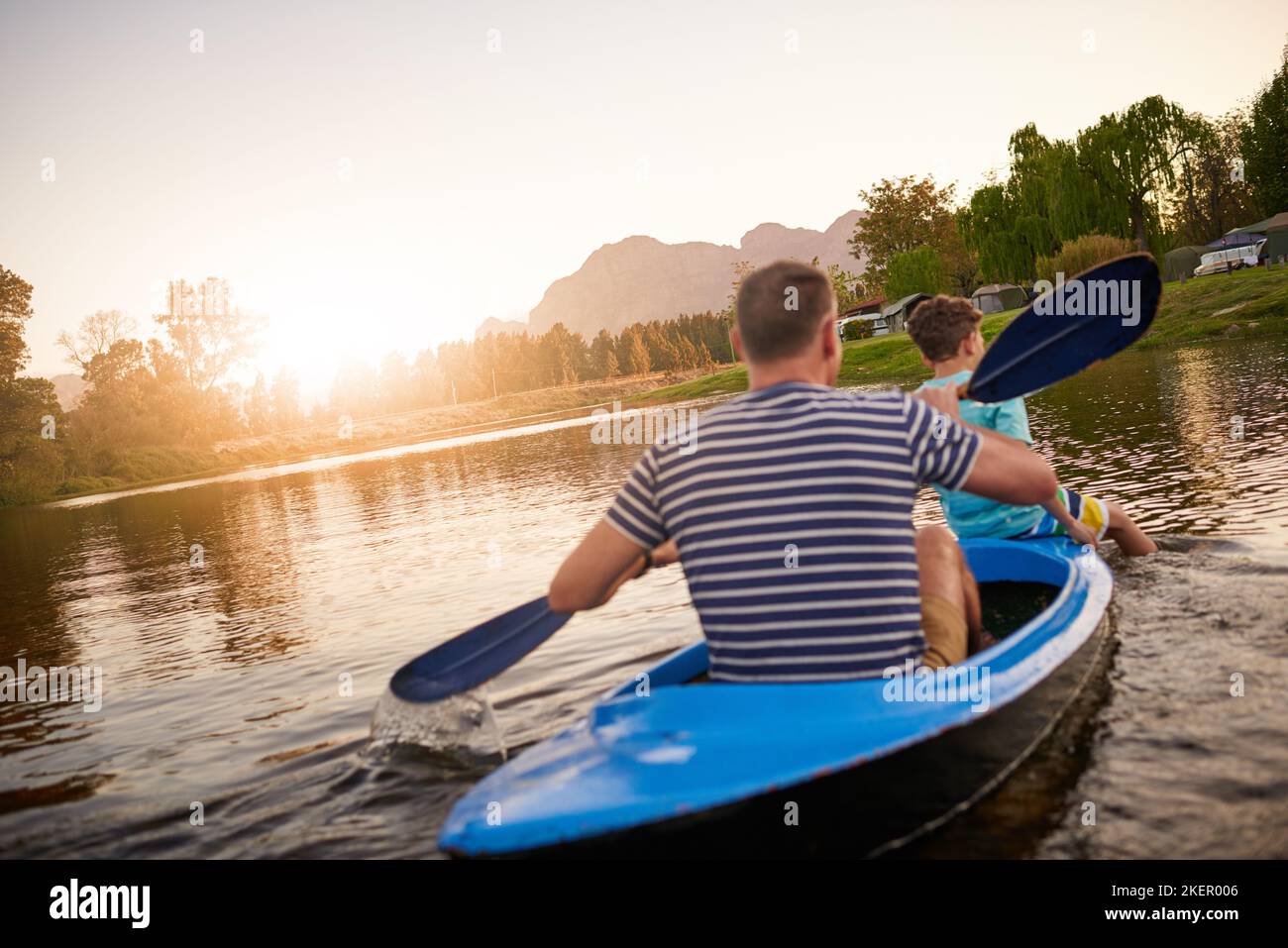 Off on another adventure. a father and son rowing a boat together on a ...