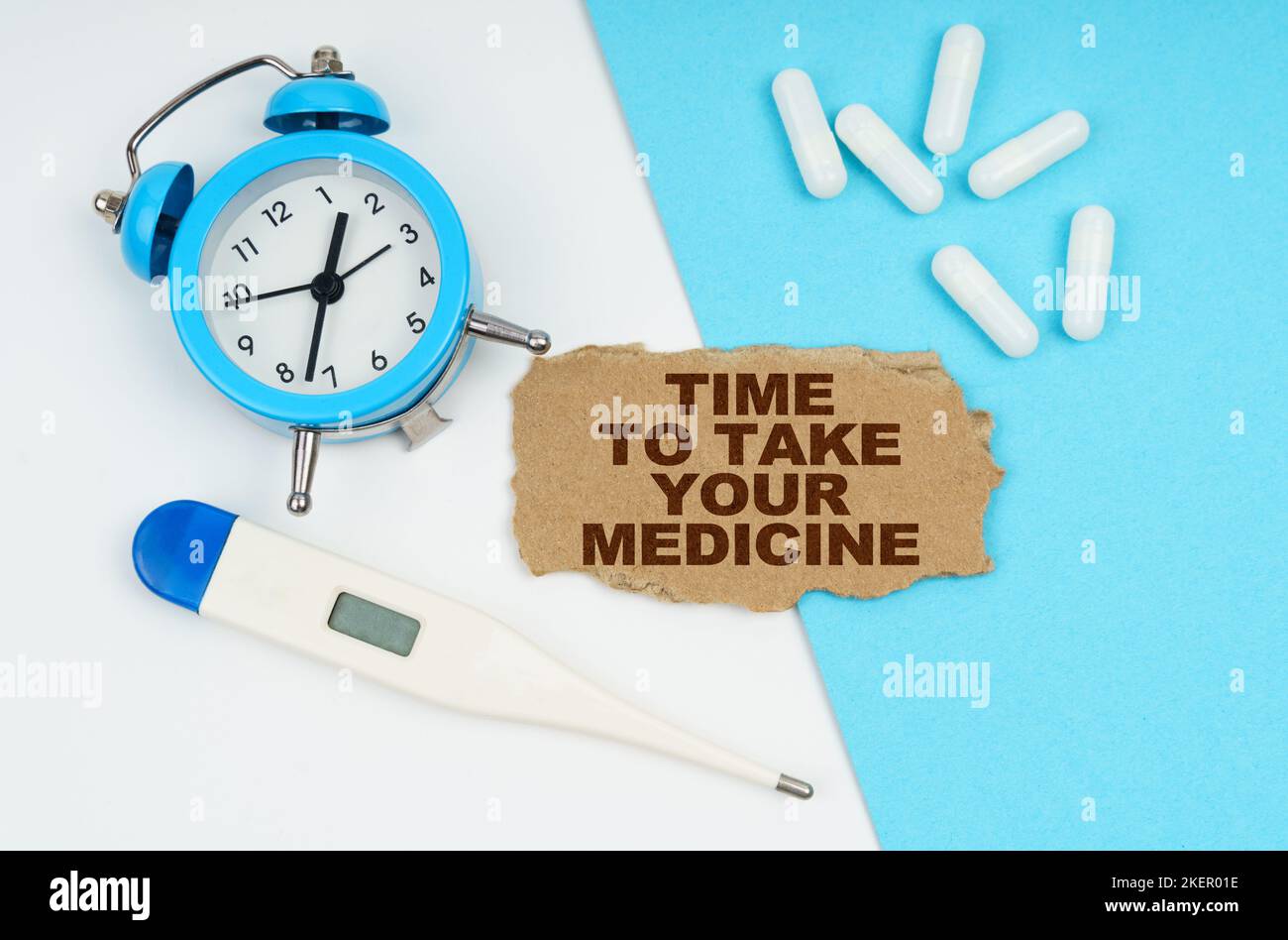 Medical concept. A clock, a thermometer, a syringe and a cardboard with ...