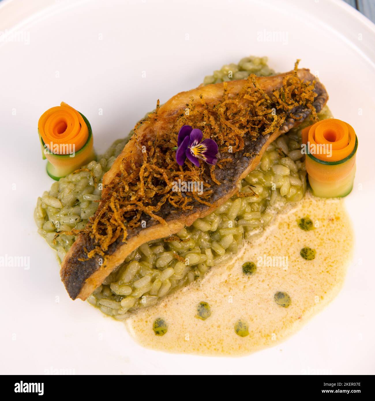 Recipe for fried fillet of sea bass with herb risotto, white wine sauce ...
