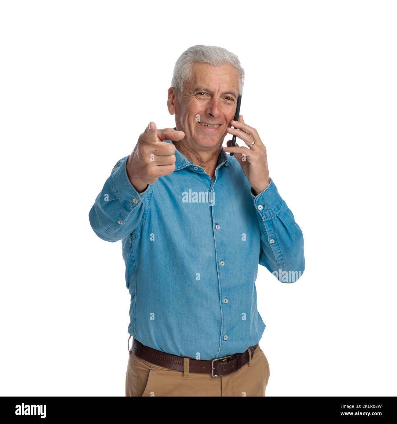 happy old man having a phone conversation pointing finger and smiling ...