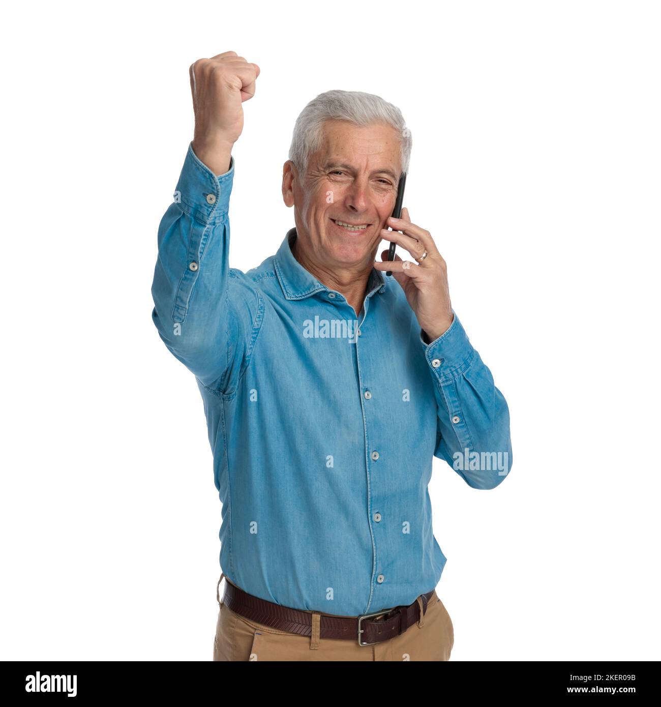 enthusiastic old guy talking on the phone and celebrating victory with ...