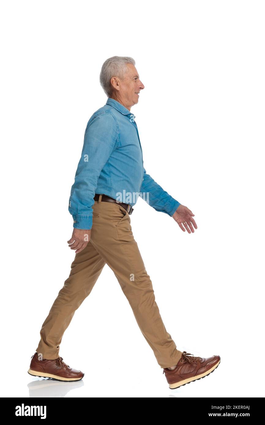 side view picture of handsome old man looking to side and stepping with ...