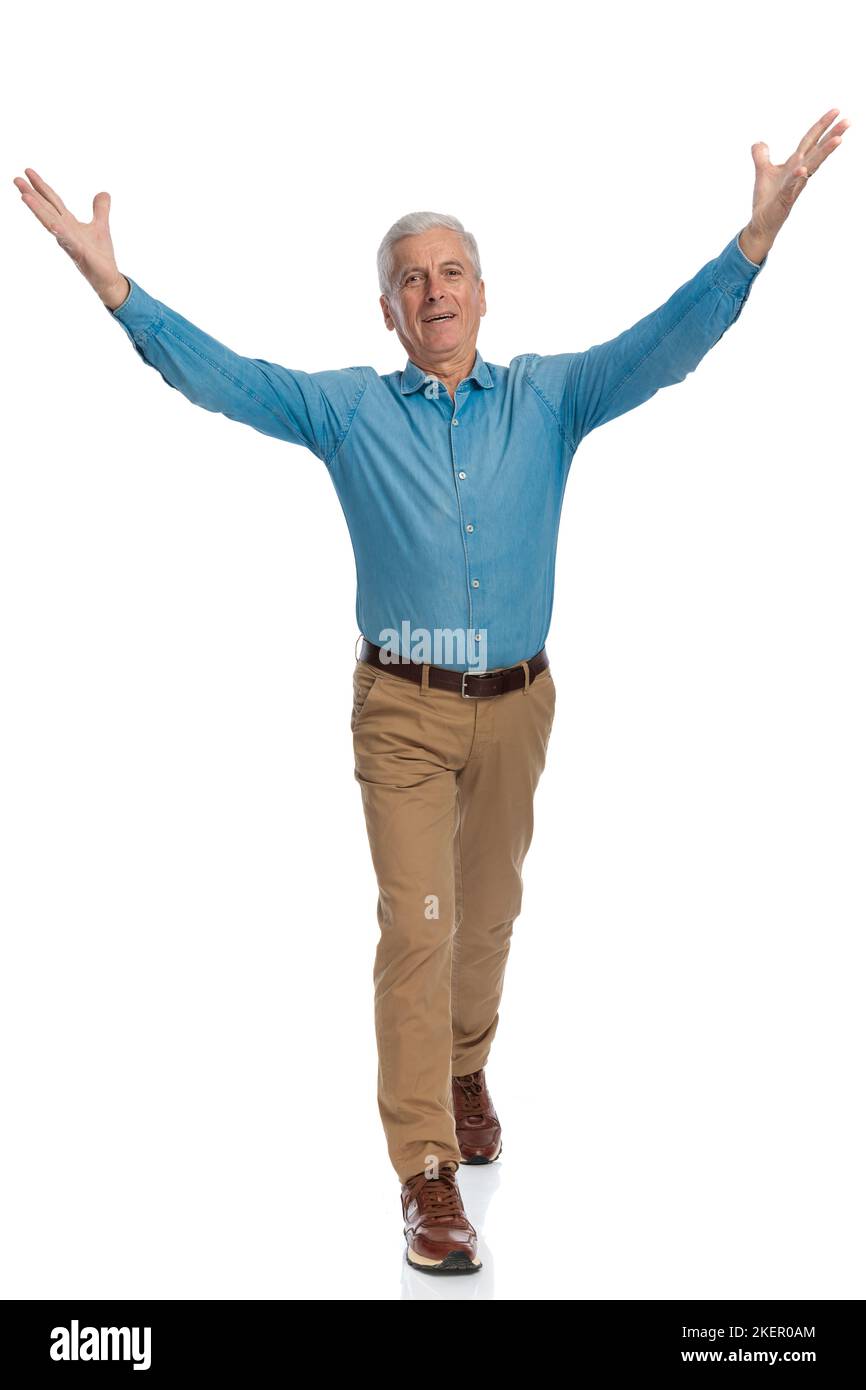 proud old man holding arms in the air and cheering the victory in front ...