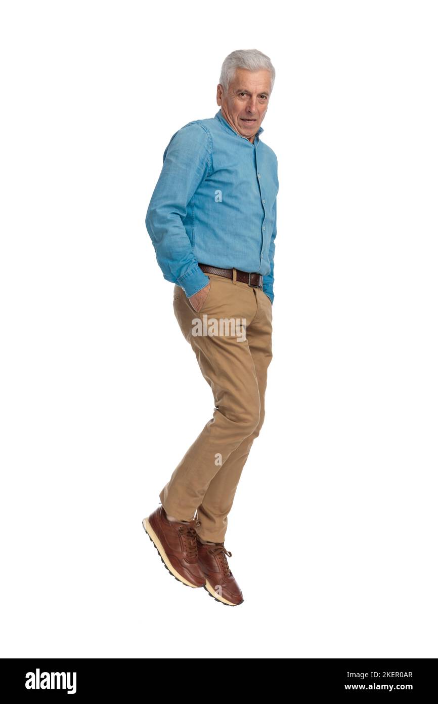 full length picture of handsome old man with hands in pockets jumping ...