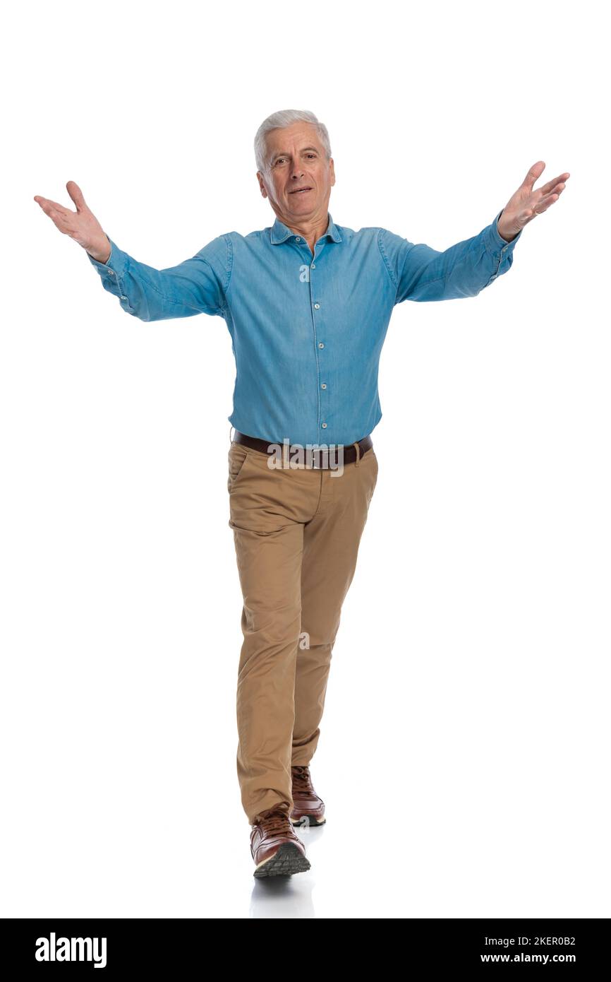grizzled hair man holding arms up, welcoming and inviting while walking ...
