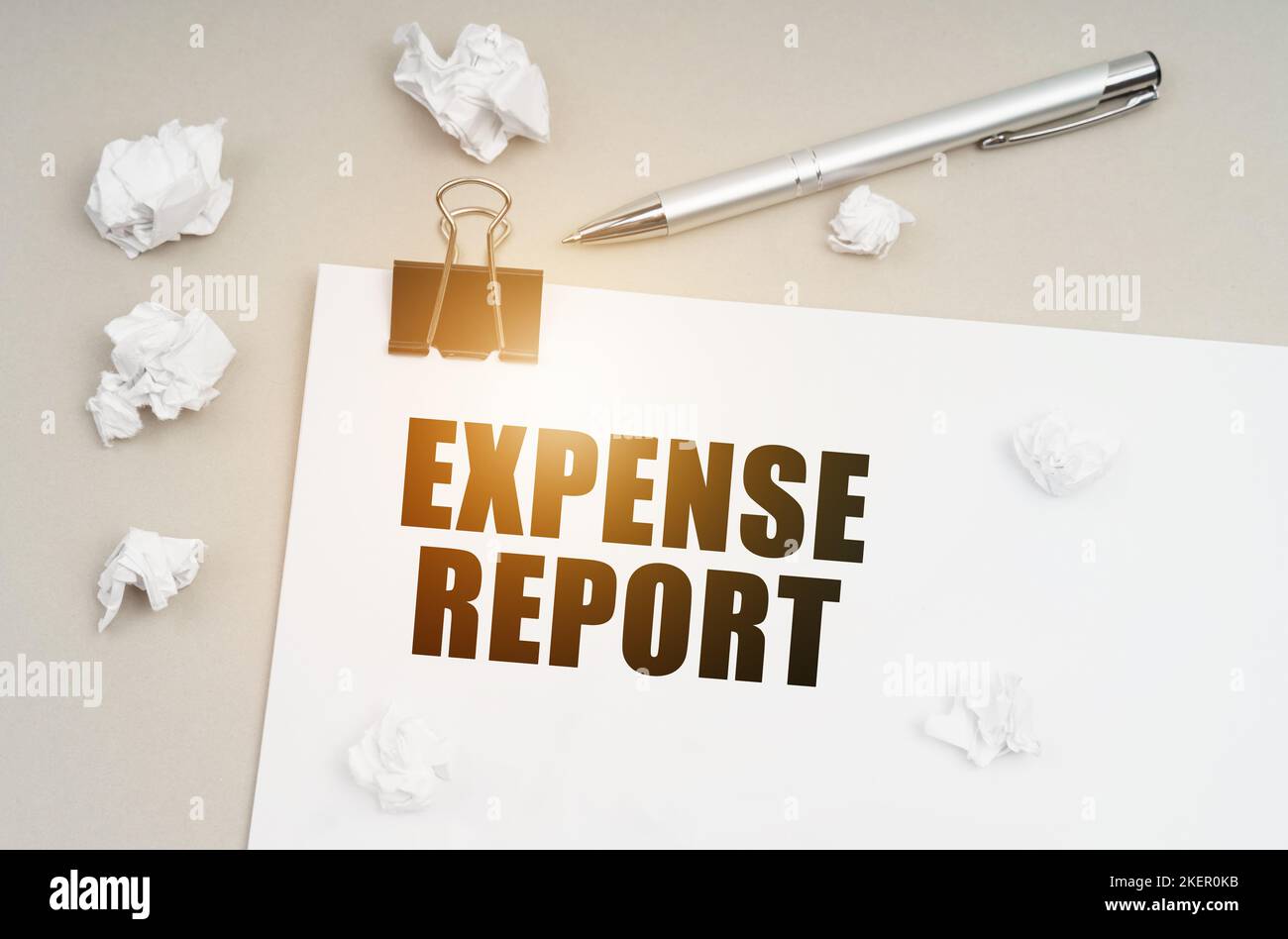 Economy and business concept. On a gray surface, a pen, crumpled paper ...