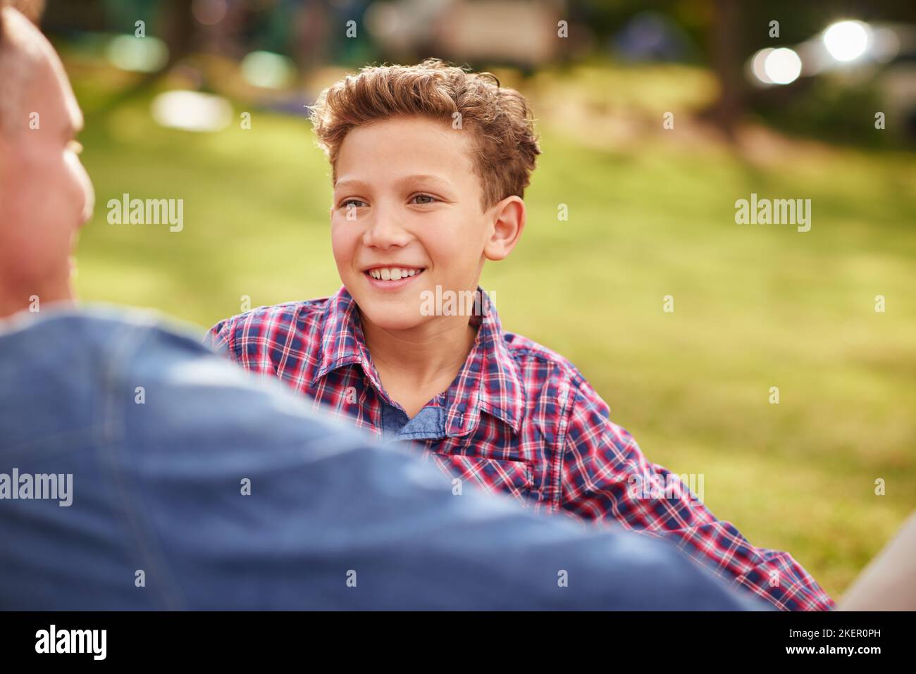 Making the most of his time with dad. a father and son talking together ...