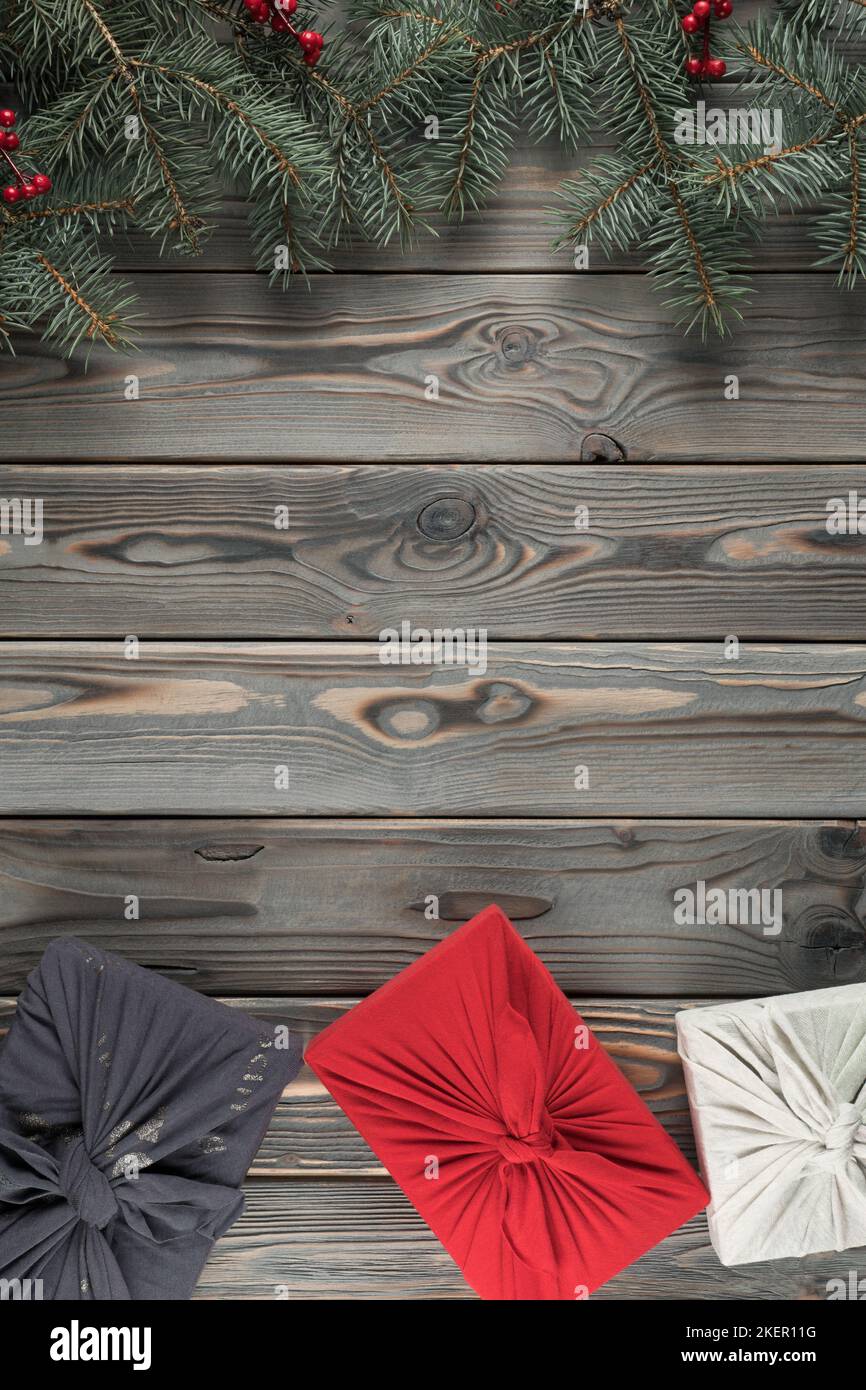 Christmas presents composition in furoshiki package, top view. Spruce ...