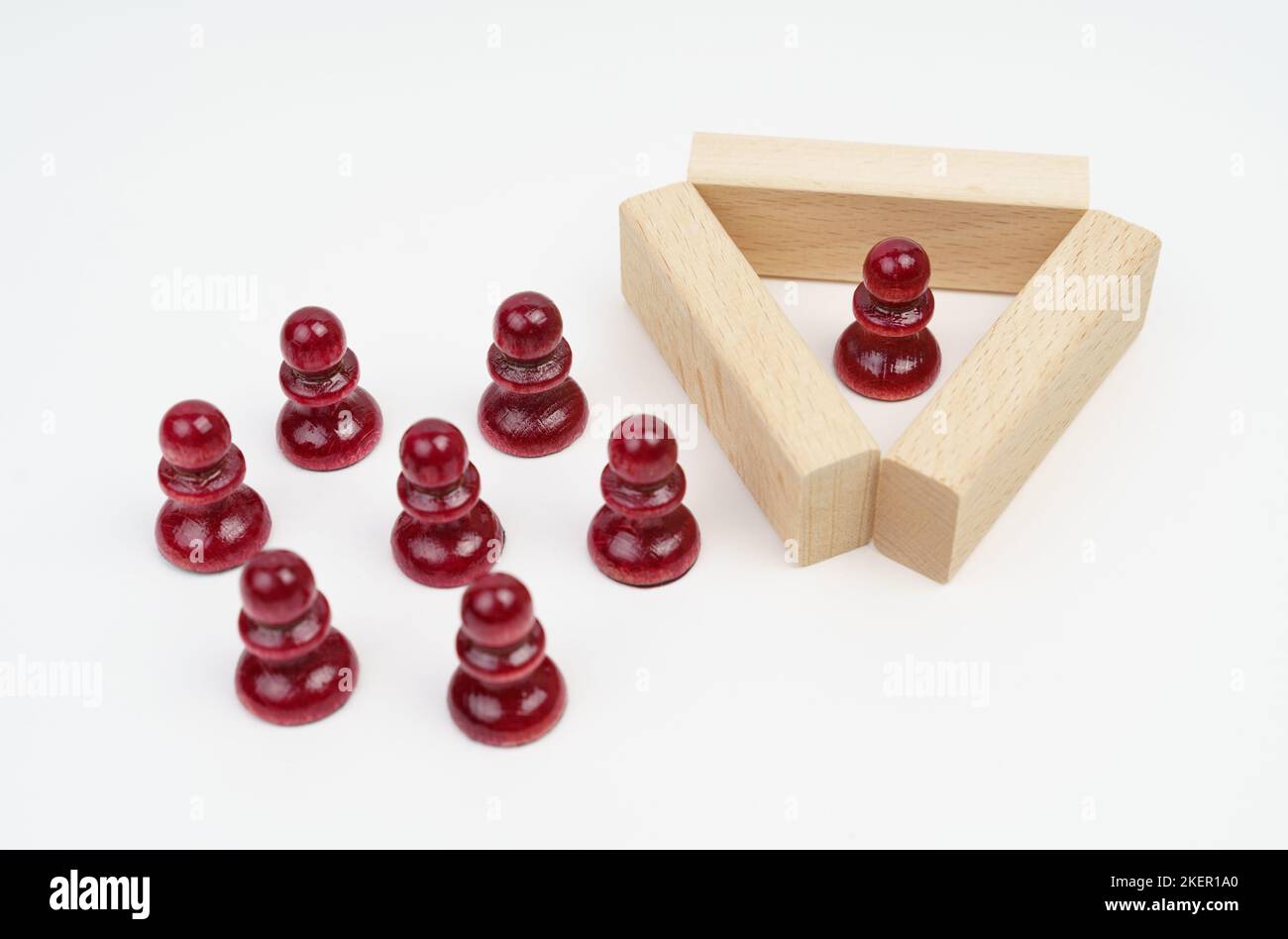 One red pawn is isolated from the rest by wooden fences. Isolated on ...
