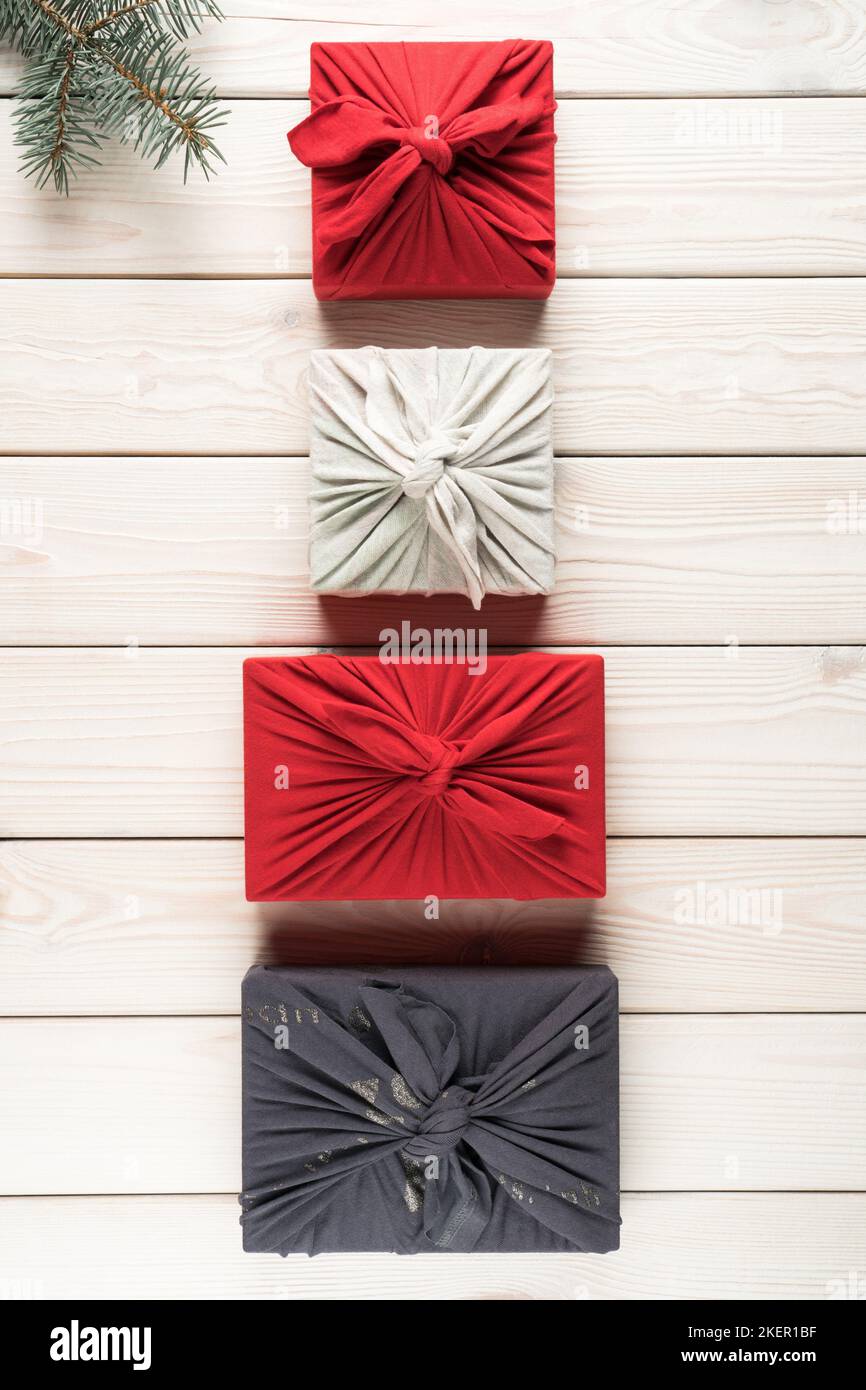 Group of christmas presents in furoshiki package, top view. Spruce ...