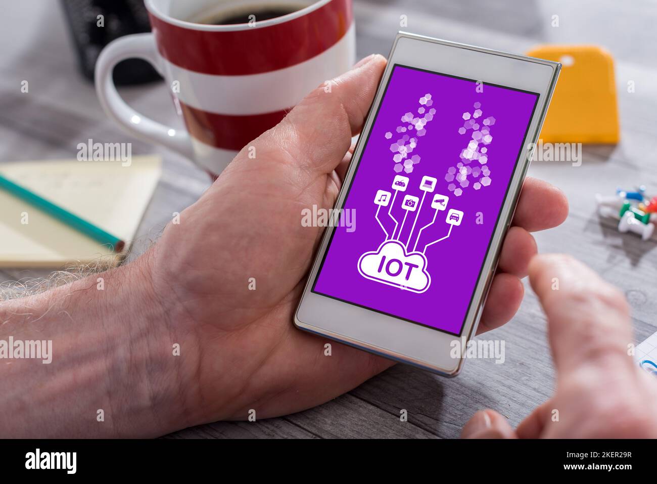 Male hand holding a smartphone with iot concept Stock Photo - Alamy