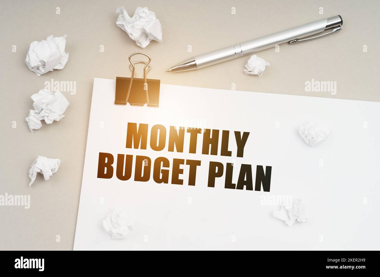 Economy and business concept. On a gray surface, a pen, crumpled paper ...