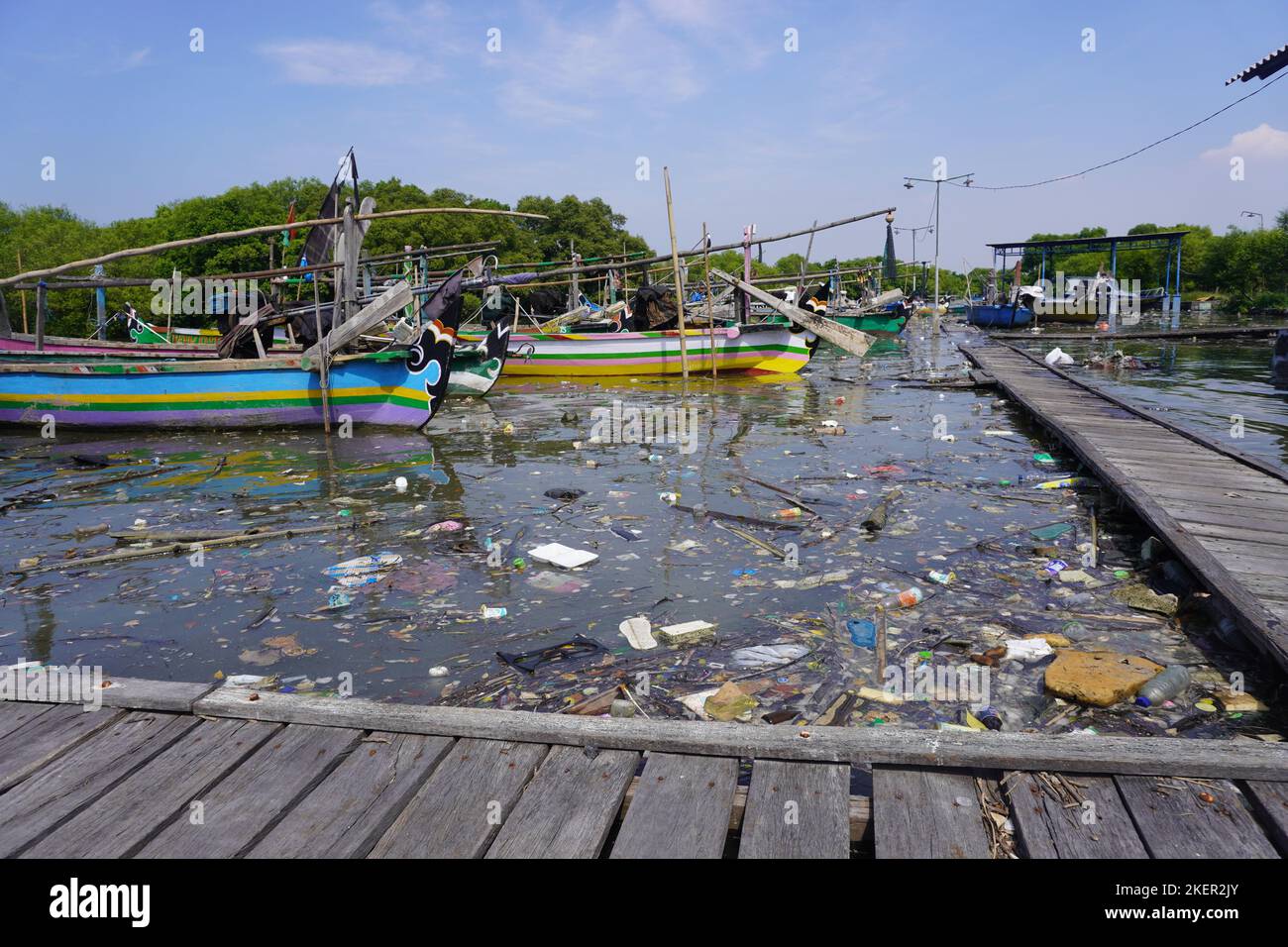 traditional fishing boat made of wood is docked on the river near the ...