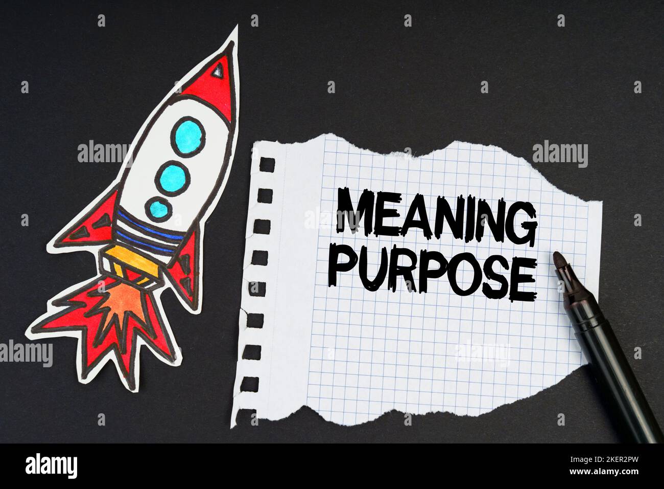 Business and finance concept. On a black background, a rocket, a marker ...