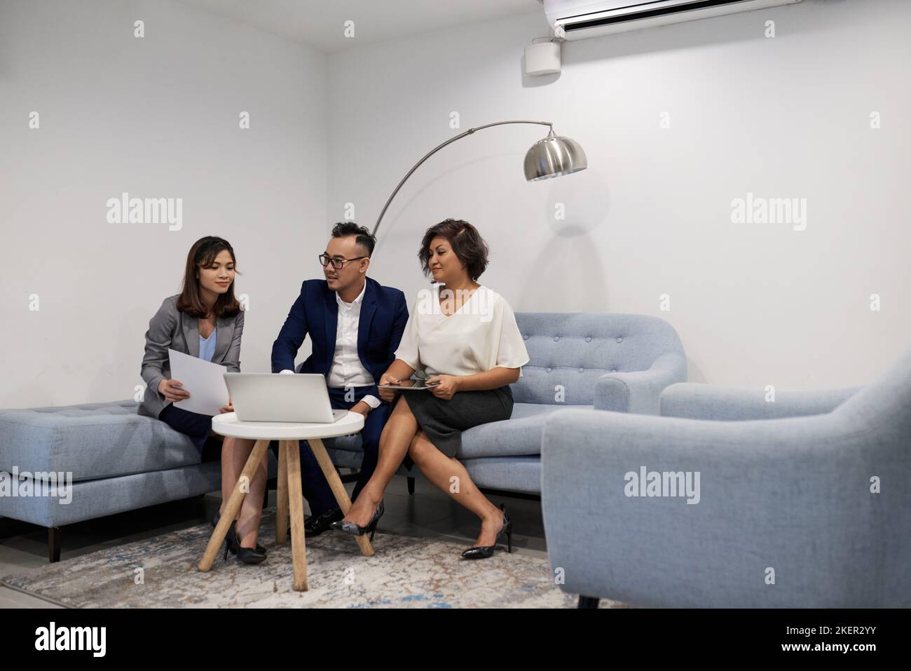 Group of Vietnamese colleagues talking in modern meeting room Stock ...