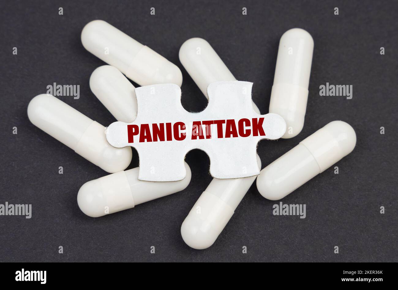 Medicine concept. On a black background, capsules and a puzzle with the ...