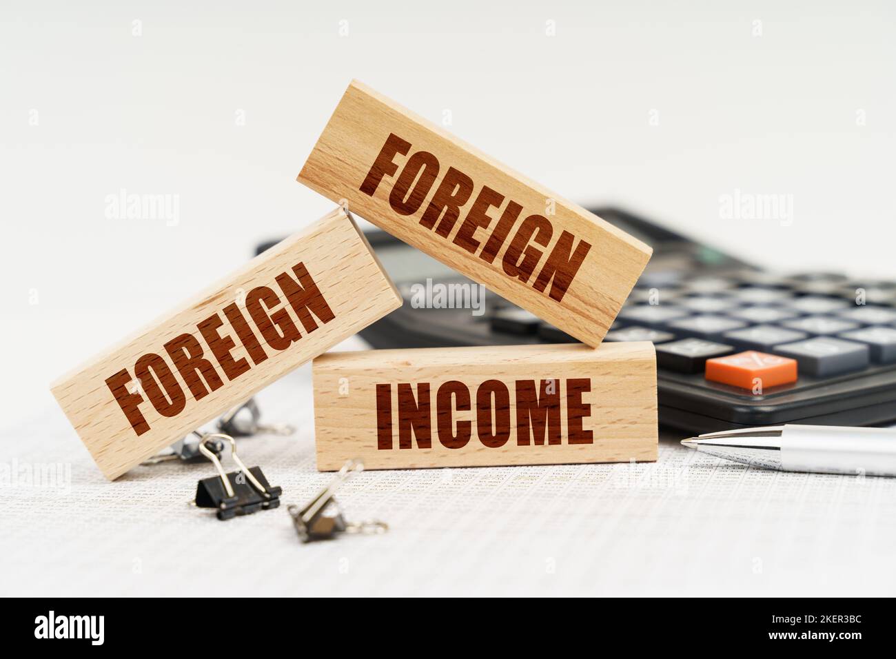 Business and Economics. On the table is a pen, a calculator and small ...