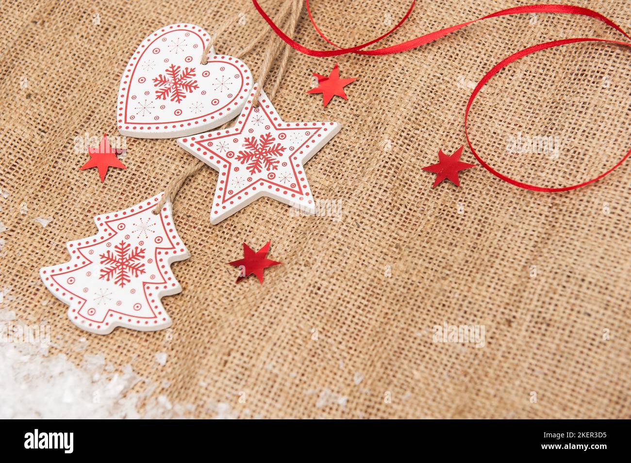 Red - white Wooden Christmas decorations on a background of burlap with ...
