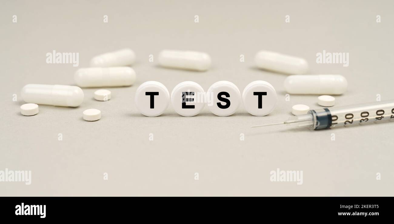 Medicine concept. On the table are capsules, a syringe and pills that ...