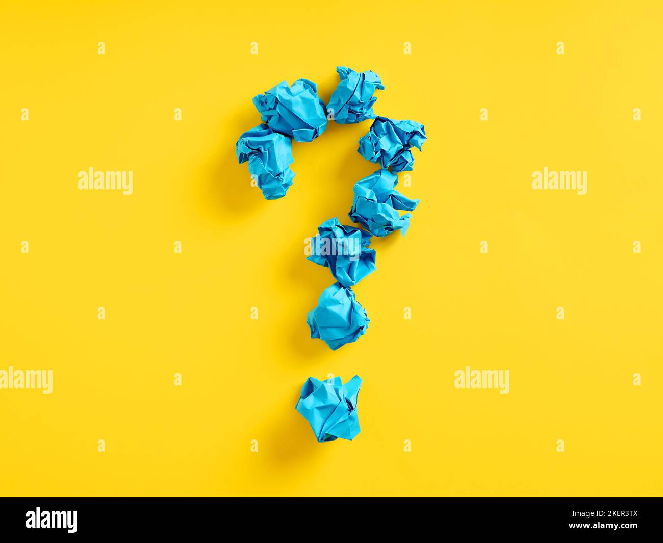 Question mark symbol made out of blue crumpled papers on yellow ...