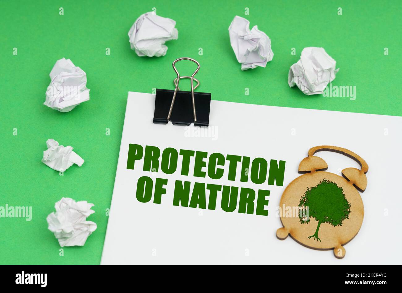 Environmental concept. On a green background there is a white sheet, on ...
