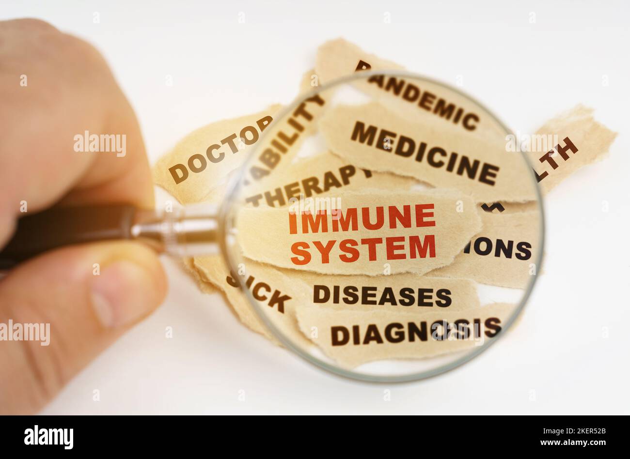 Medical concept. A man looks through a magnifying glass at scraps of ...