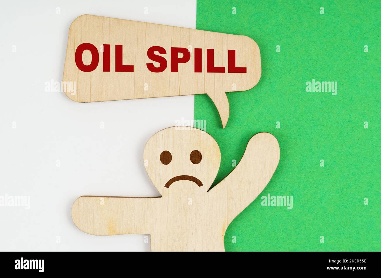 Environmental concept. On a green and white background, a sad wooden ...