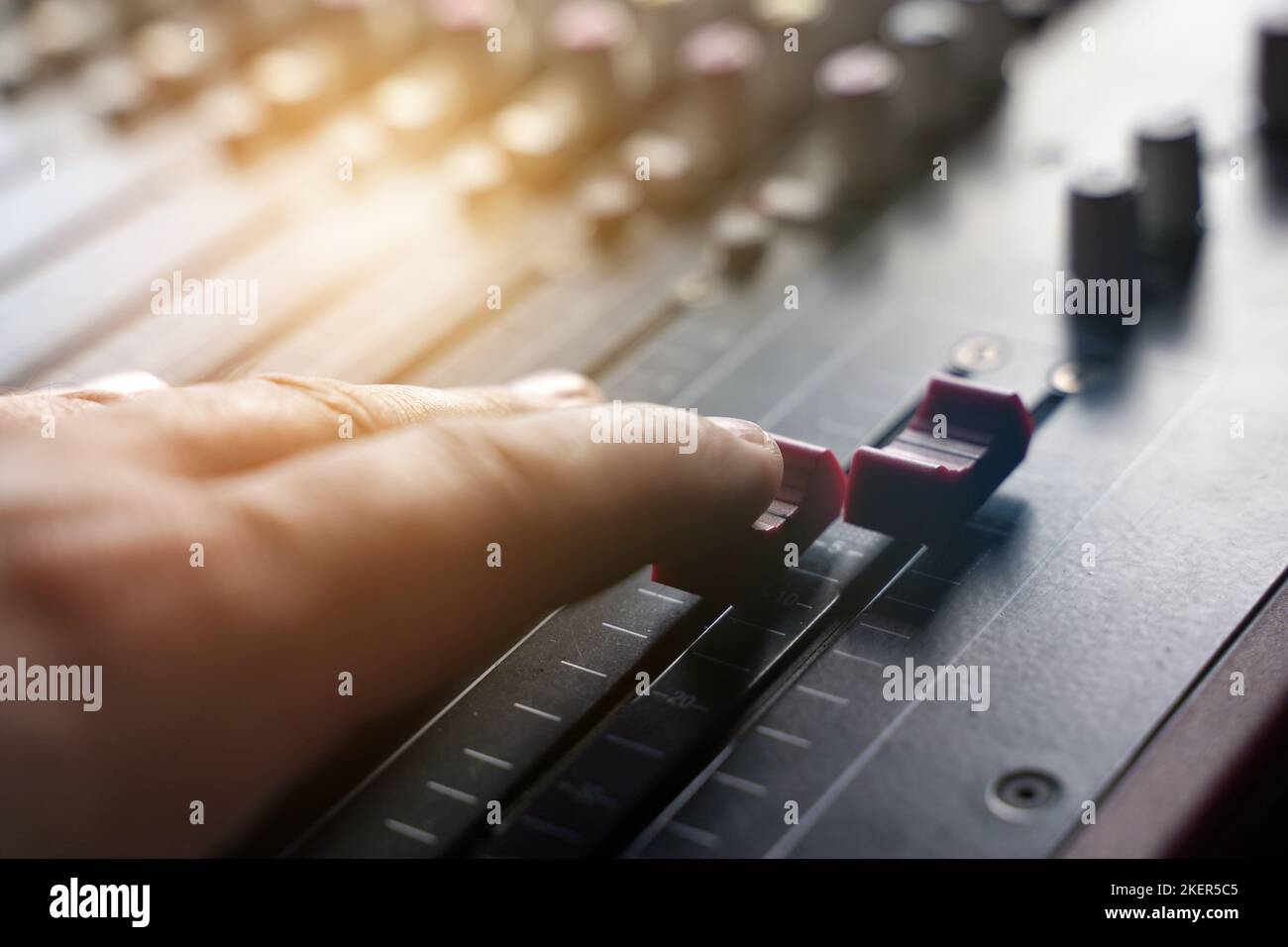 Entertainment industry. The person controls the regulator on the music console Stock Photo - Alamy
