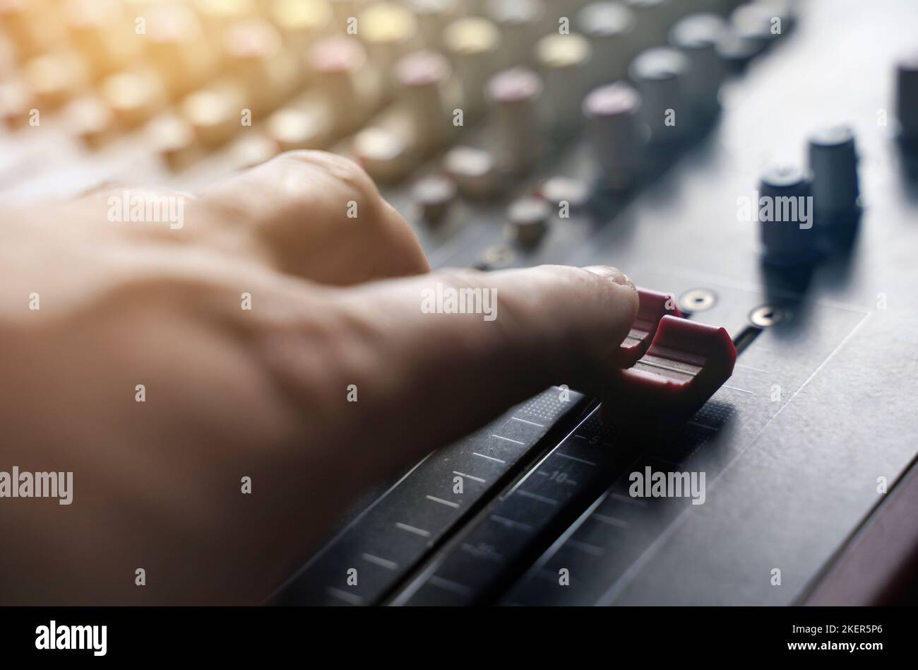 Entertainment industry. The person controls the regulator on the music console Stock Photo - Alamy