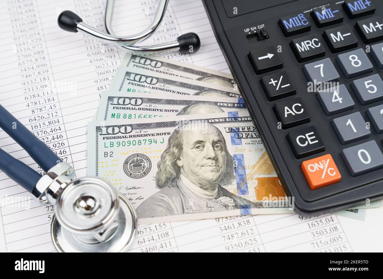Stethoscope over dollars, calculator and papers. Banking business ...