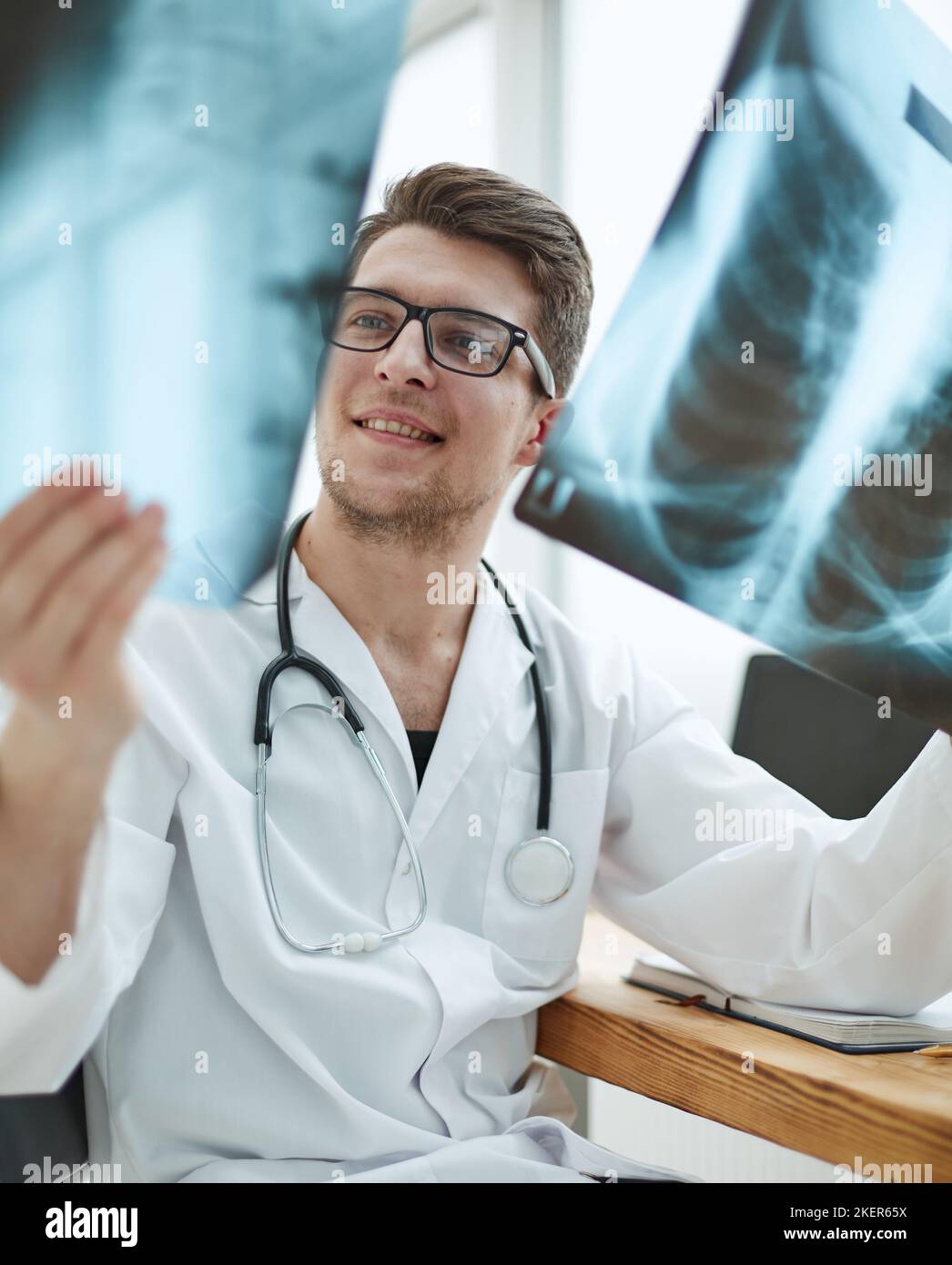 Male doctor radiologist examines x-rays in a medical office Stock Photo ...