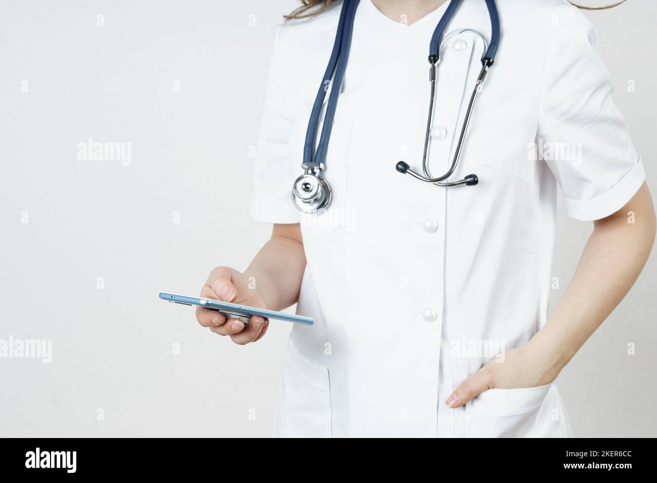 Medicine and health concept. Young woman doctor message in mobile phone ...