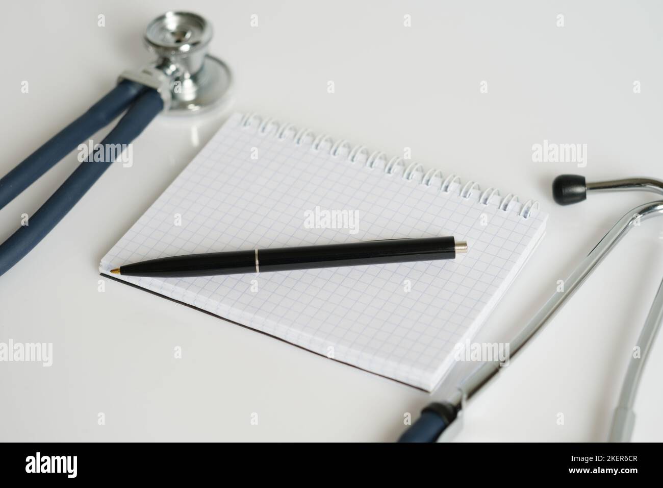 Stethoscope and notebook with pen isolated on white background. The ...