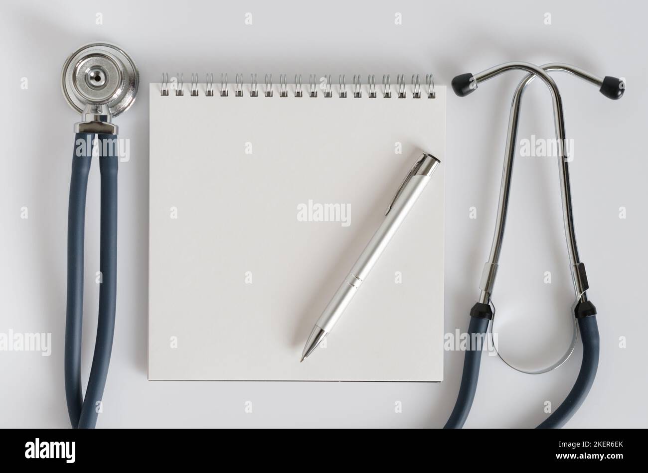 Stethoscope and notebook with pen isolated on white background. The ...