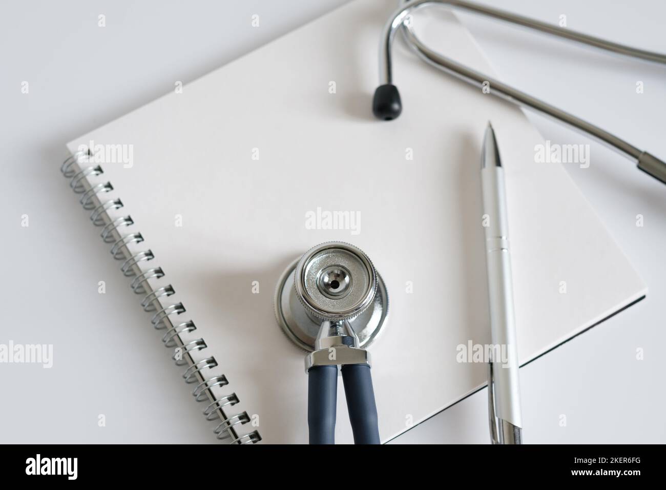 Stethoscope and notebook with pen isolated on white background. The ...