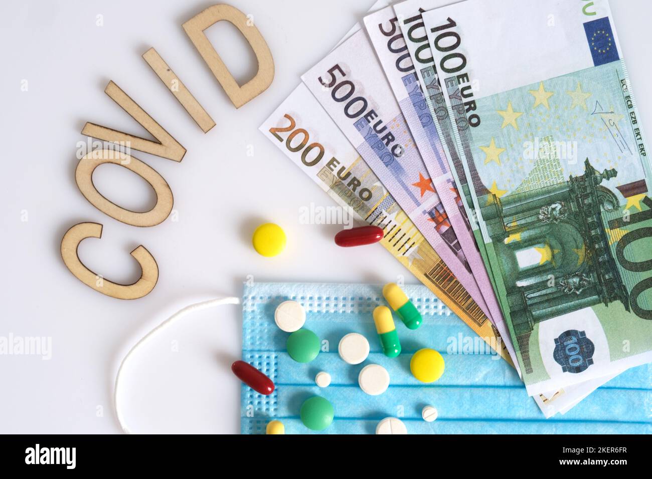 The inscription Covid , dollars, medical mask, surrounded by drugs and ...