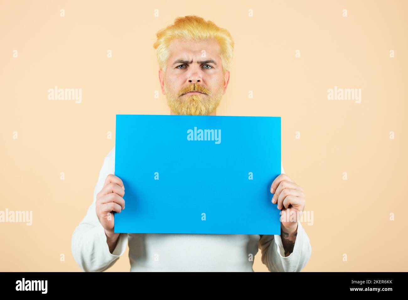 Man holding empty blank board. Sale. Caucasian blond male model posing ...
