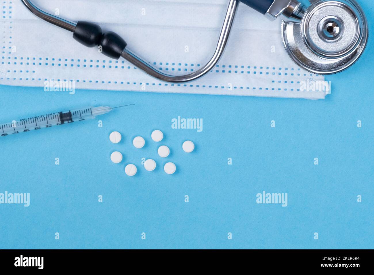 Medical supplies: mask, tablets, stethoscope, syringe isolated on a ...