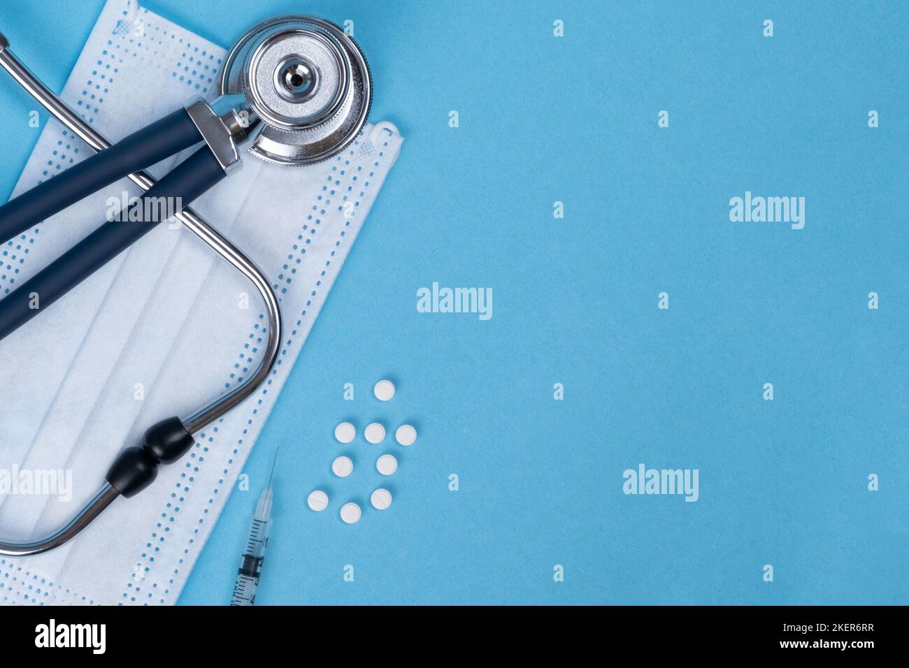 Medical supplies: mask, tablets, stethoscope, syringe isolated on a ...